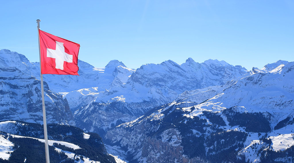 Swiss Alps with Flag - Tara's Travels